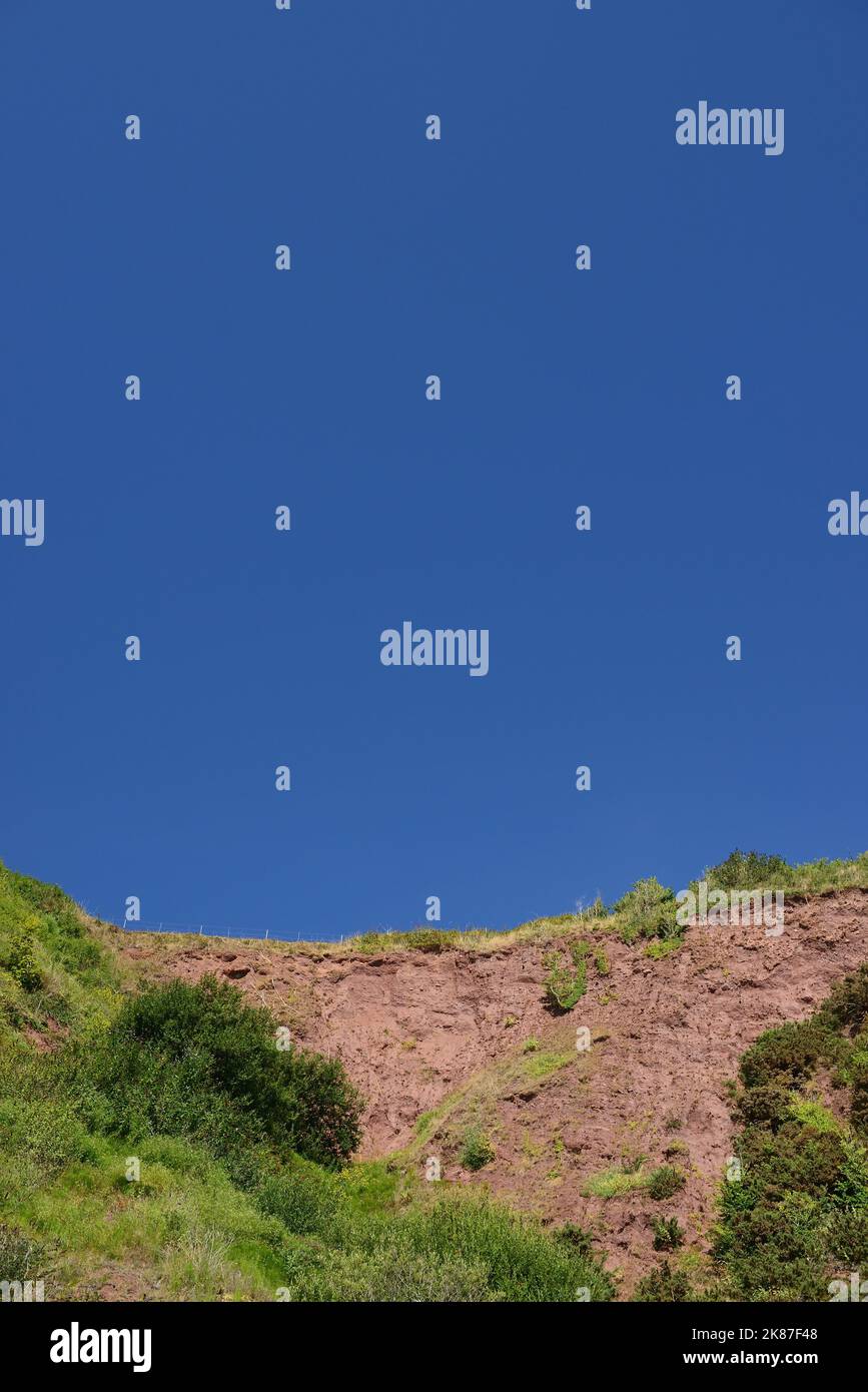 A deep blue sky above a red sandstone clifftop, photographed with a ...