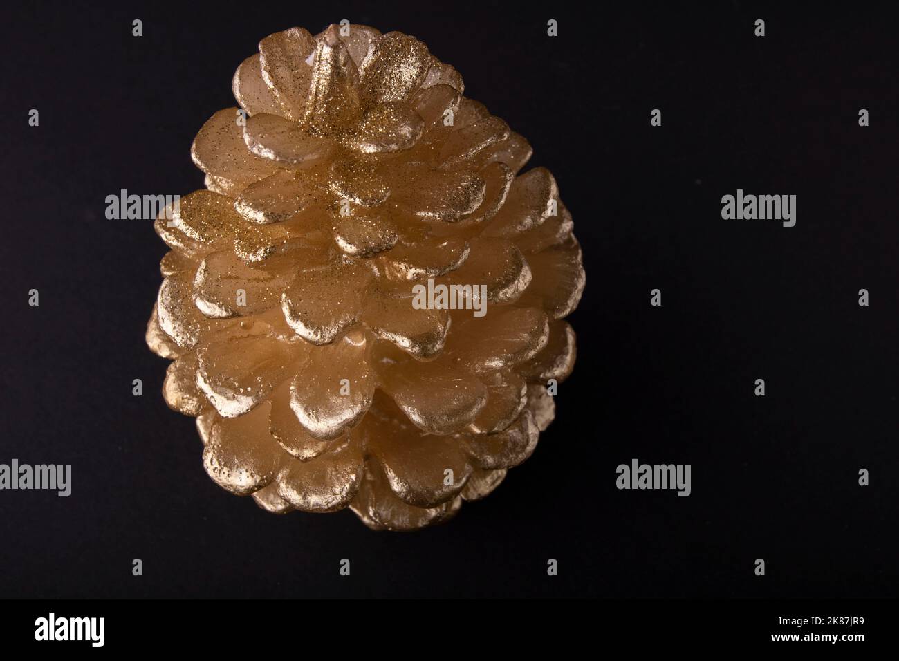 candles on a black background in the form of a cone and a fir tree ...