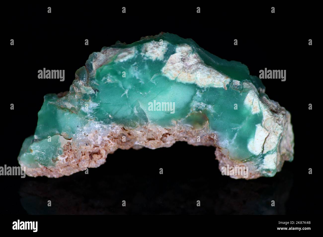 Chrysoprase on a black background - a sample of green raw collection ...