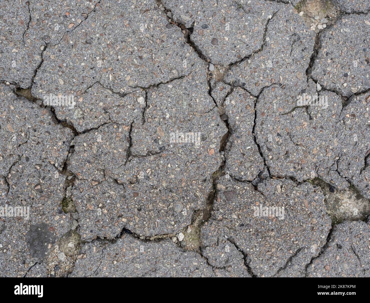 Old cracked grey asphalt surface. Cracked asphalt texture for ...