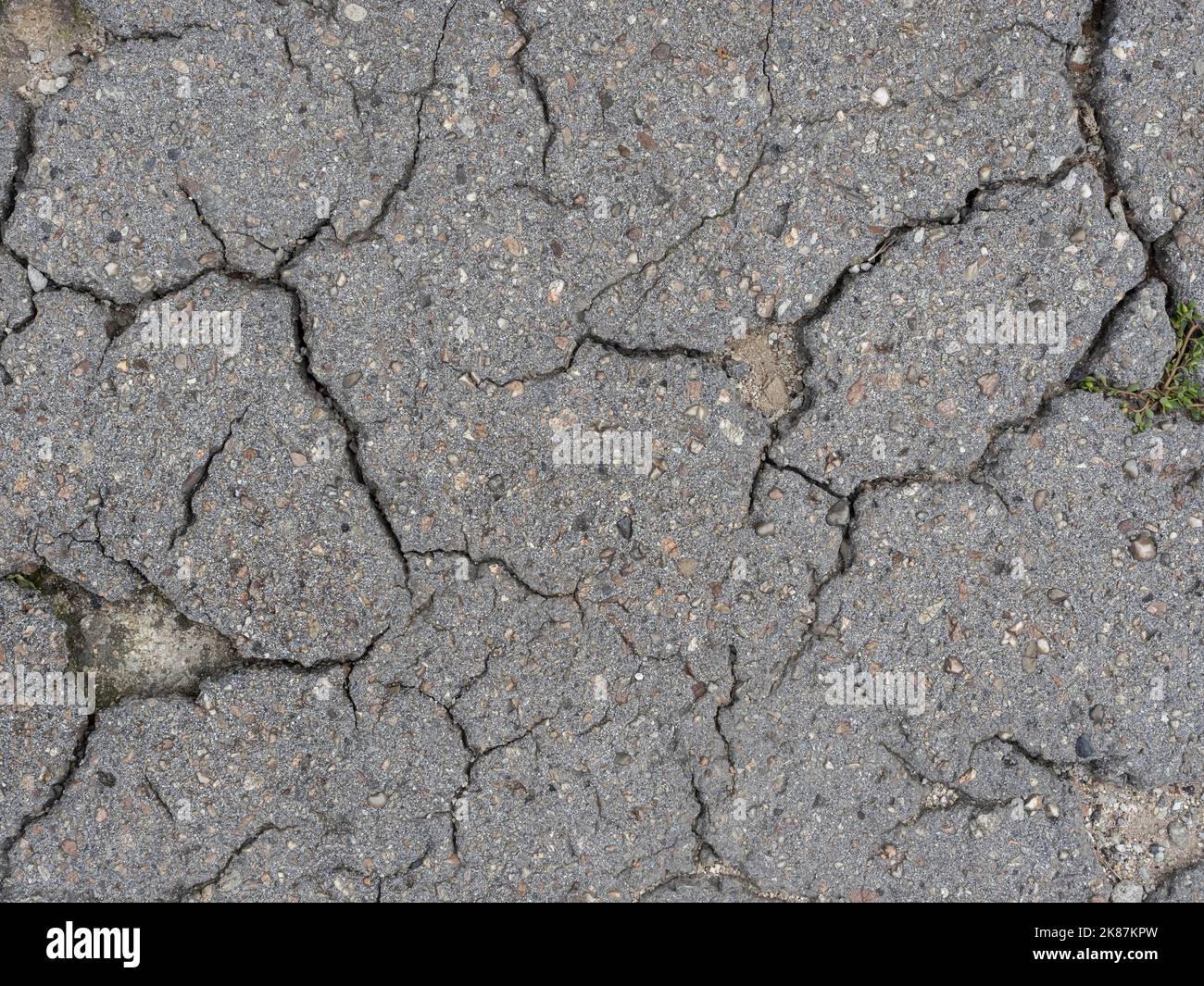 Old cracked grey asphalt surface. Cracked asphalt texture for ...