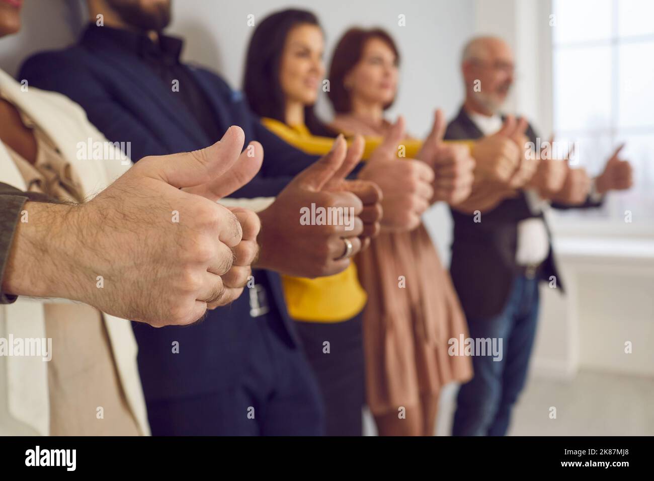 Diverse multiracial team of happy business men and women showing thumbs ...