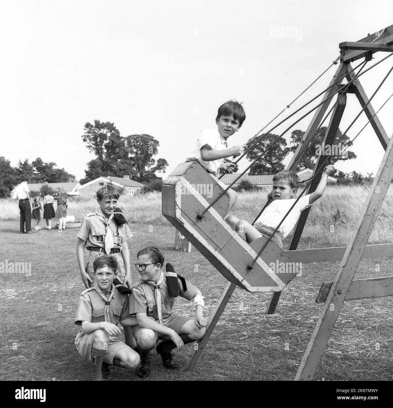 1960s, historical, two young boys riding in a wooden boat on a wooden ... 1960s, historical, two young boys riding in a wooden boat on a wooden ...