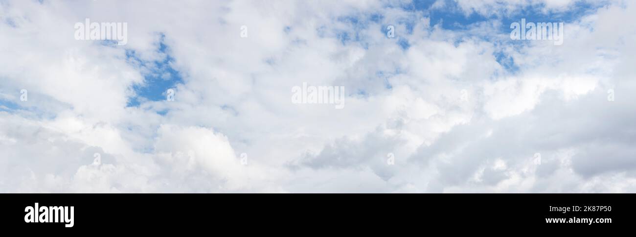 Extra large panorama of a sky with white fluffy clouds in front of a ...