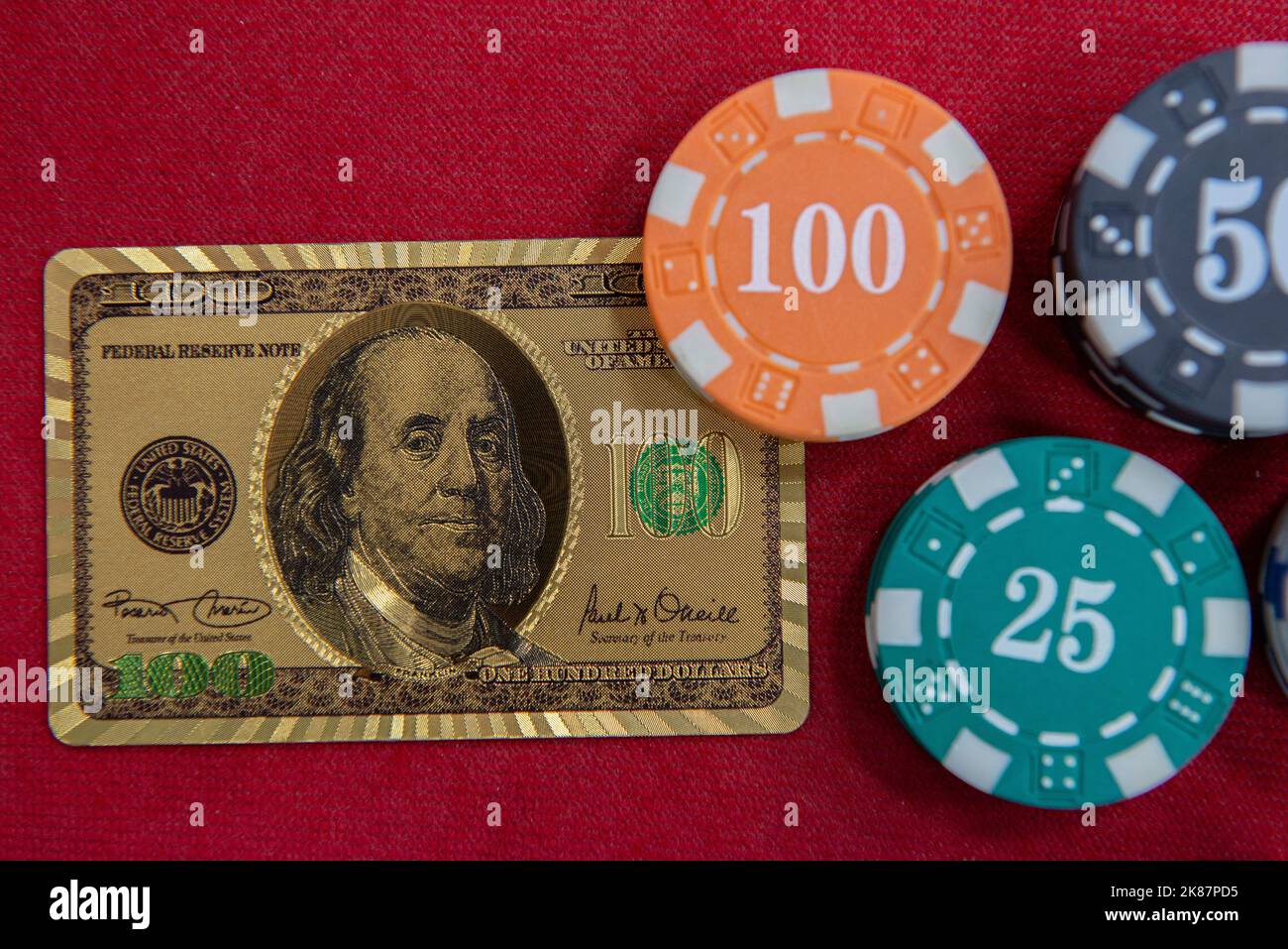 Top view of golden 100 dollar playing cards next to stacks of chips on ...