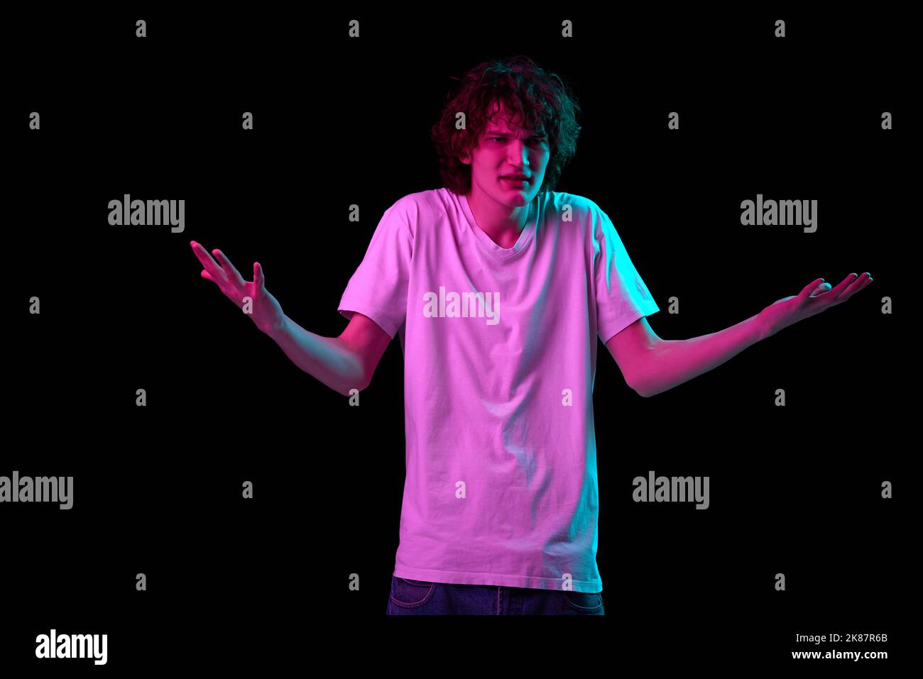 Looks annoyed. Young man with discontent and undercurrent gesturing ...