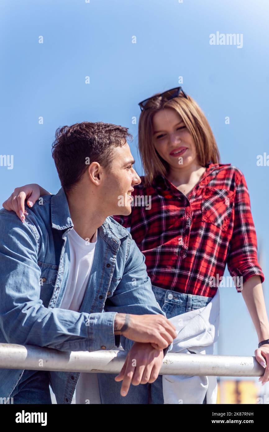 Cute girl hugging her boyfriend while standing Stock Photo - Alamy
