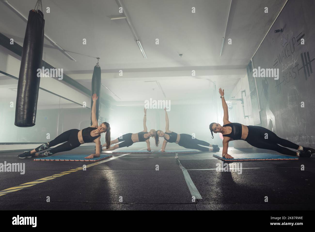 Women in black and white sportswear on a real group body Combat workout ...