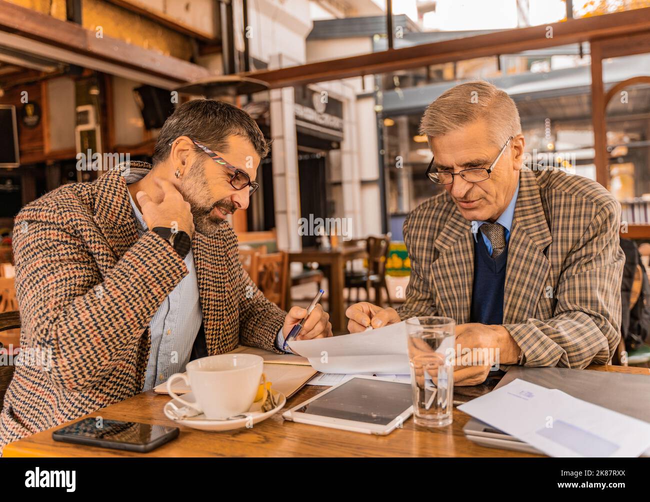 Two senior and handsome businessmen are writing the plans Stock Photo ...
