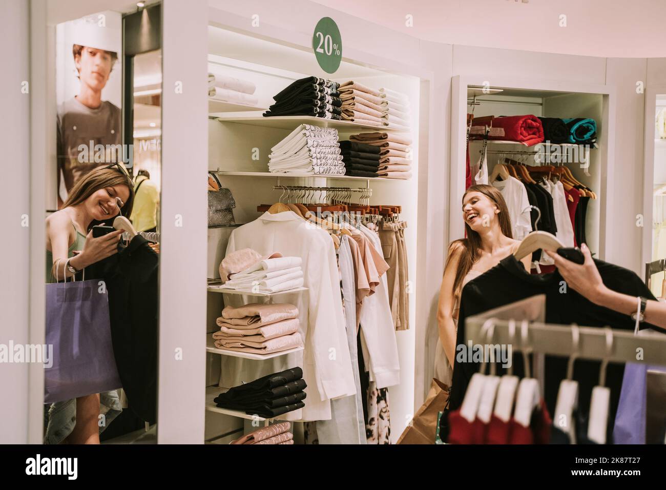 Two beautiful girls having fun at the fashion shop at the mall Stock ...