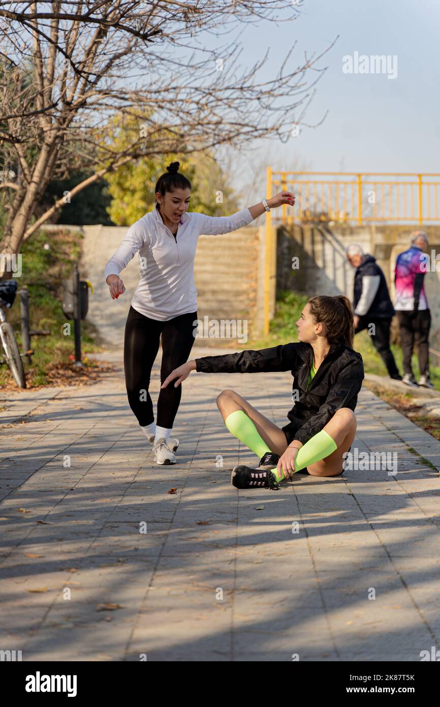 Attractive fit girl is running to help her friend while injuring ...