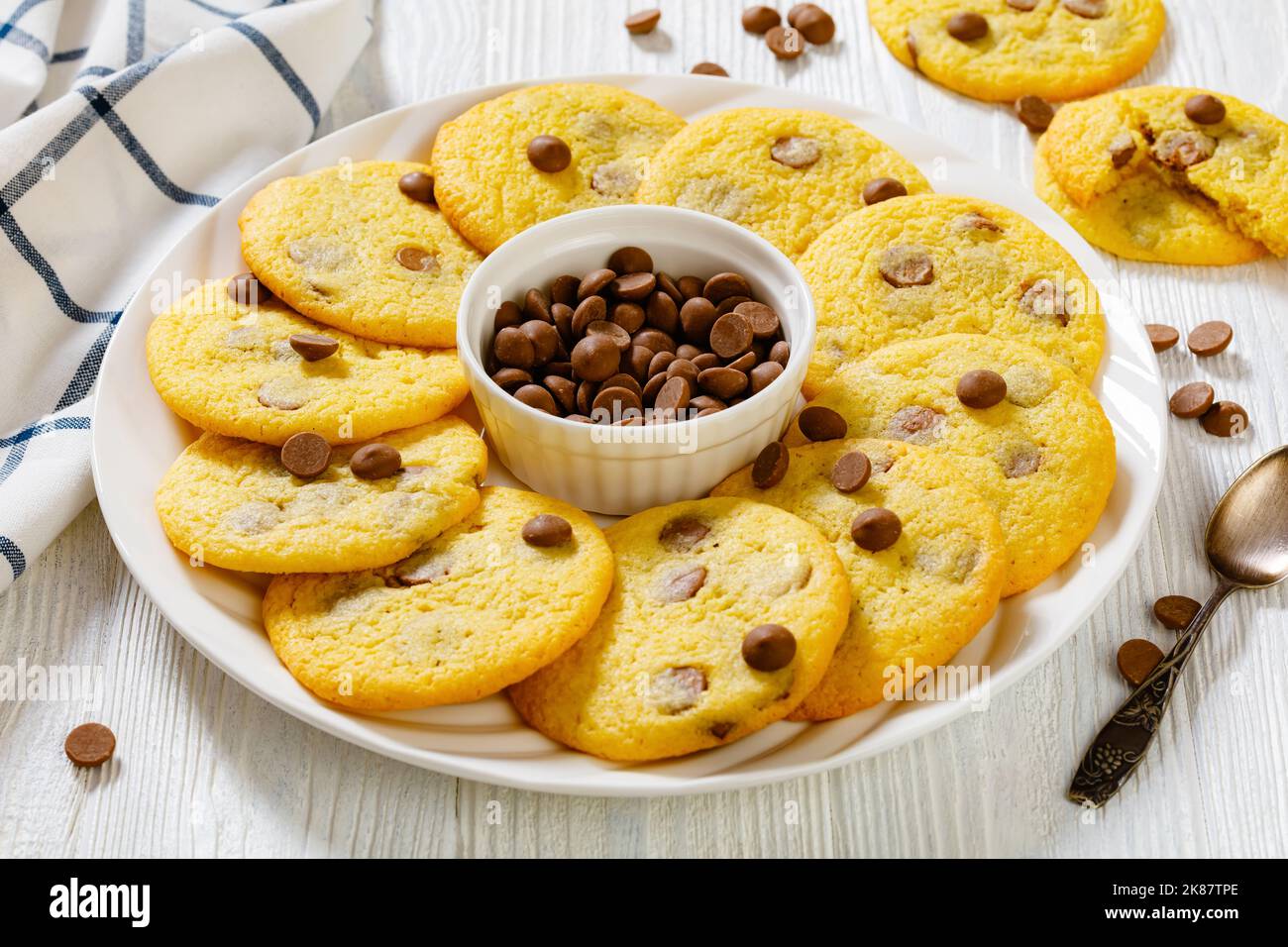 chocolate chip lemon yellow cookies on white plate on white wood table ...