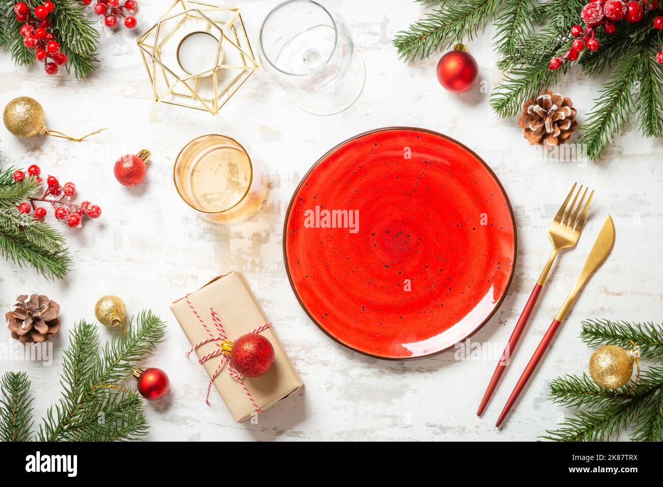 Christmas table setting with plate, cutlery and christmas decorations ...