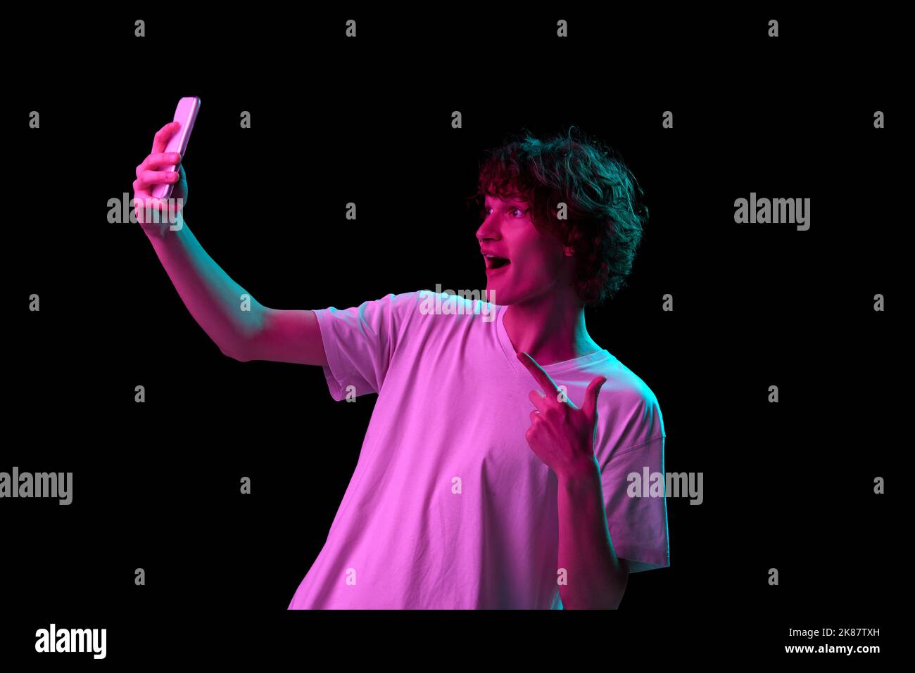 Taking selfie. Young handsome boy using smartphone isolated on ...