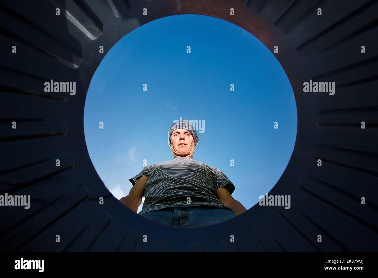 A man looking into a dustbin taken from inside the bin Stock Photo - Alamy