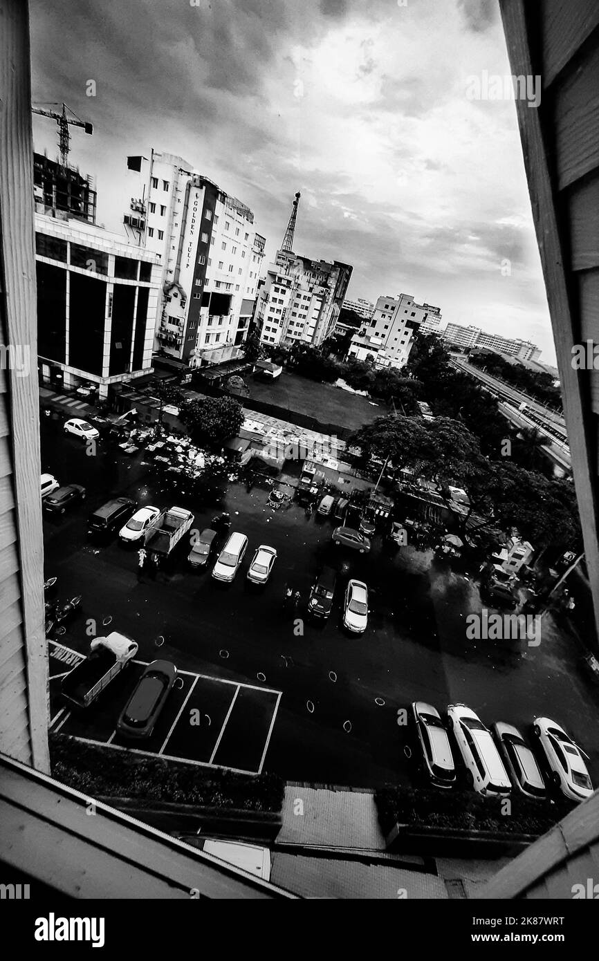 A grayscale shot of the street view from a window in Kolkata, India ...