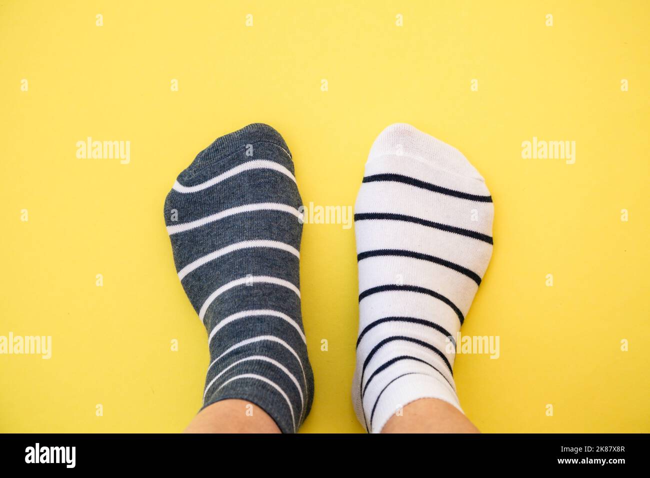Odd socks day concept. Mismatch socks at blue Stock Photo - Alamy