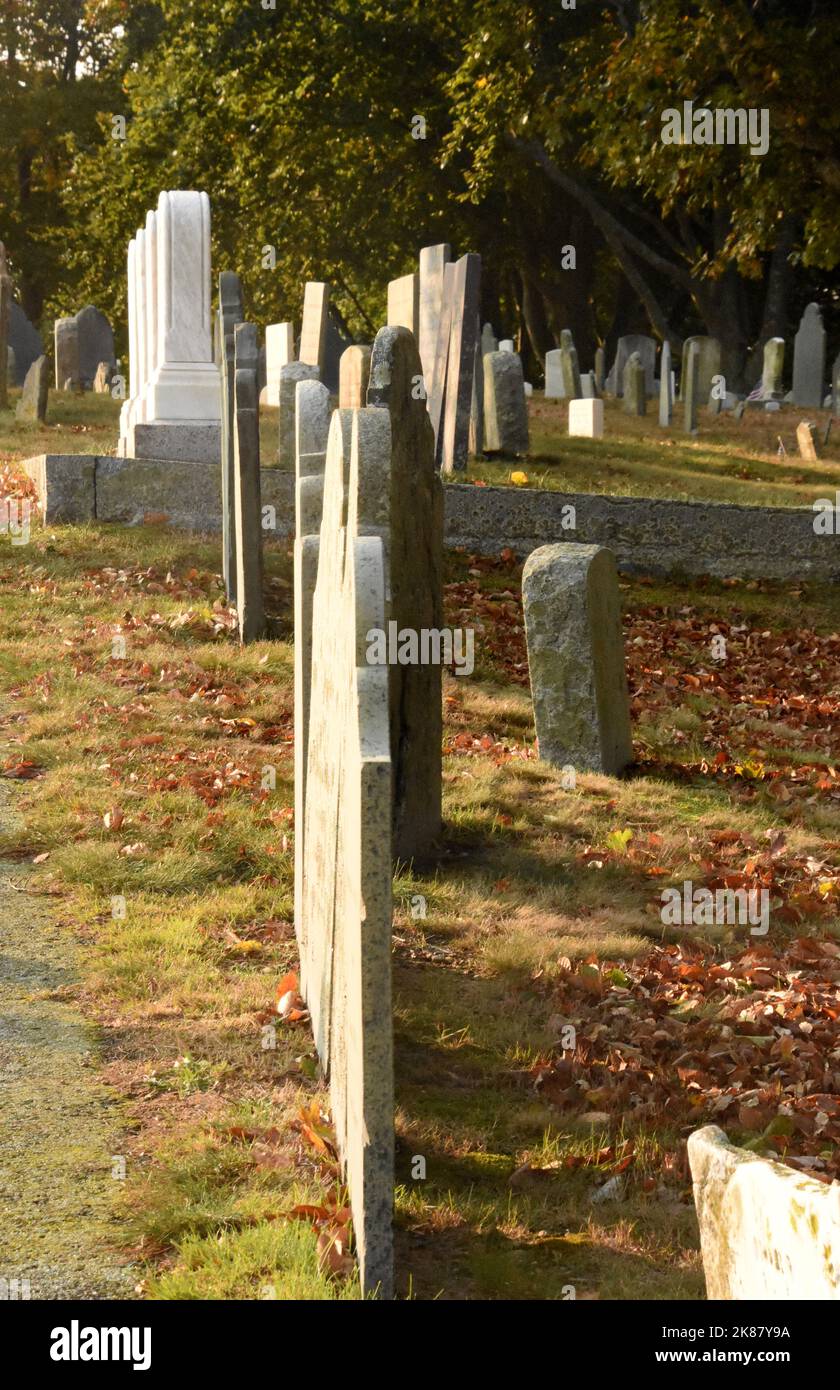 Old memorial stones and grave markers in a cemetery in New England ...
