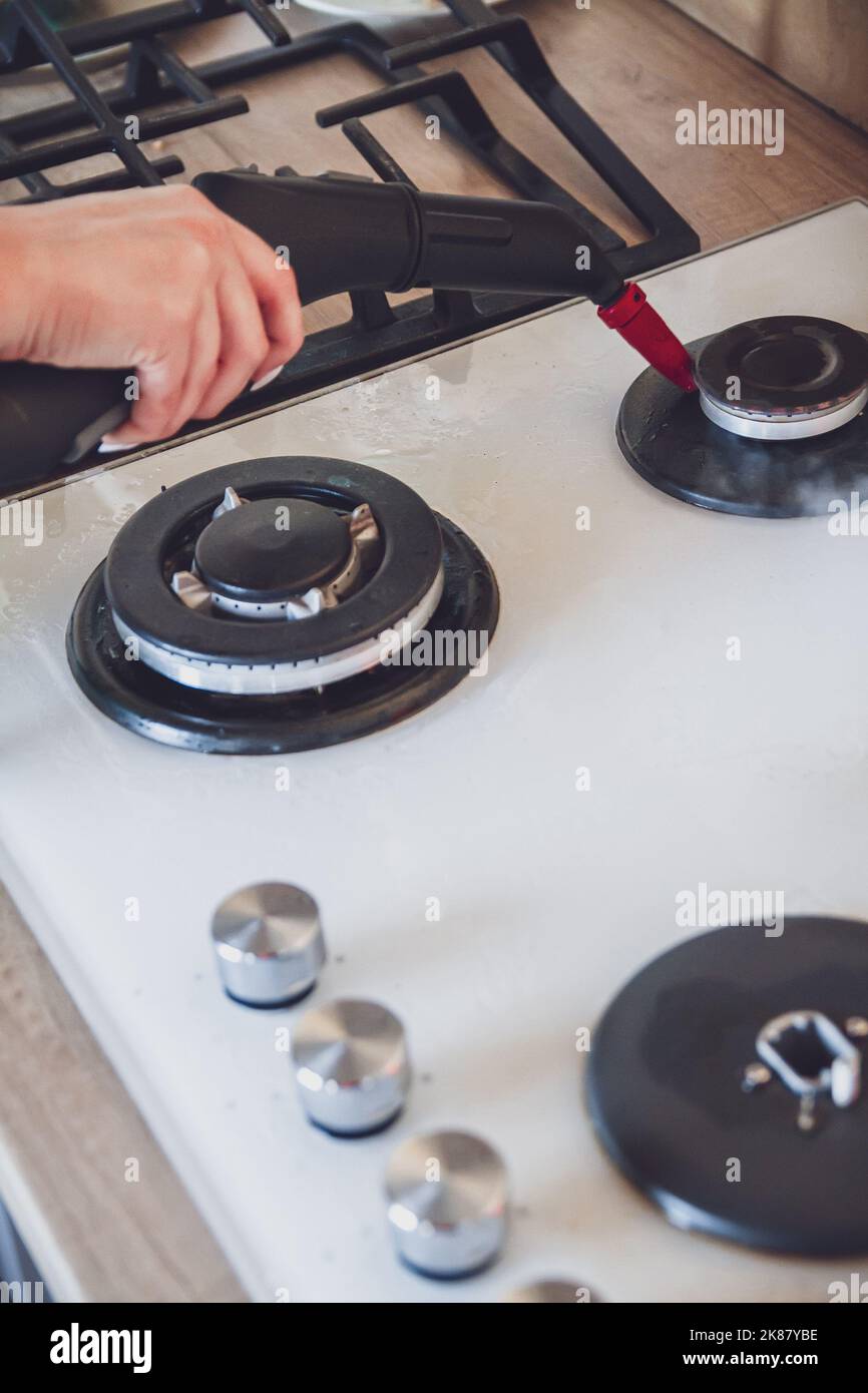 Glass ceramic stove cleaning with a steam cleaner, house disinfe Stock ...