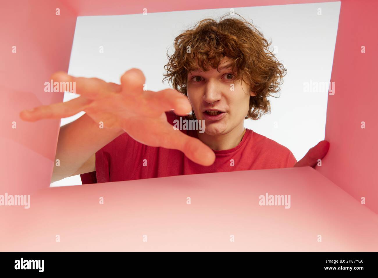 Emotional man unpacking opening carton box and looking inside. Delivery ...