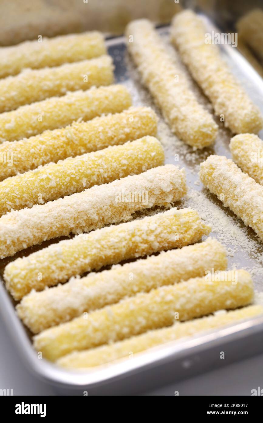 Mozzarella sticks with breaded crumbs in cooking tray ( Preparing to ...