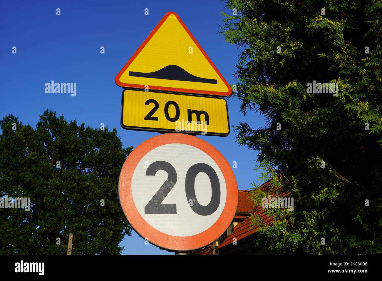 A closeup shot of European road signs for a bump with speed limit ...