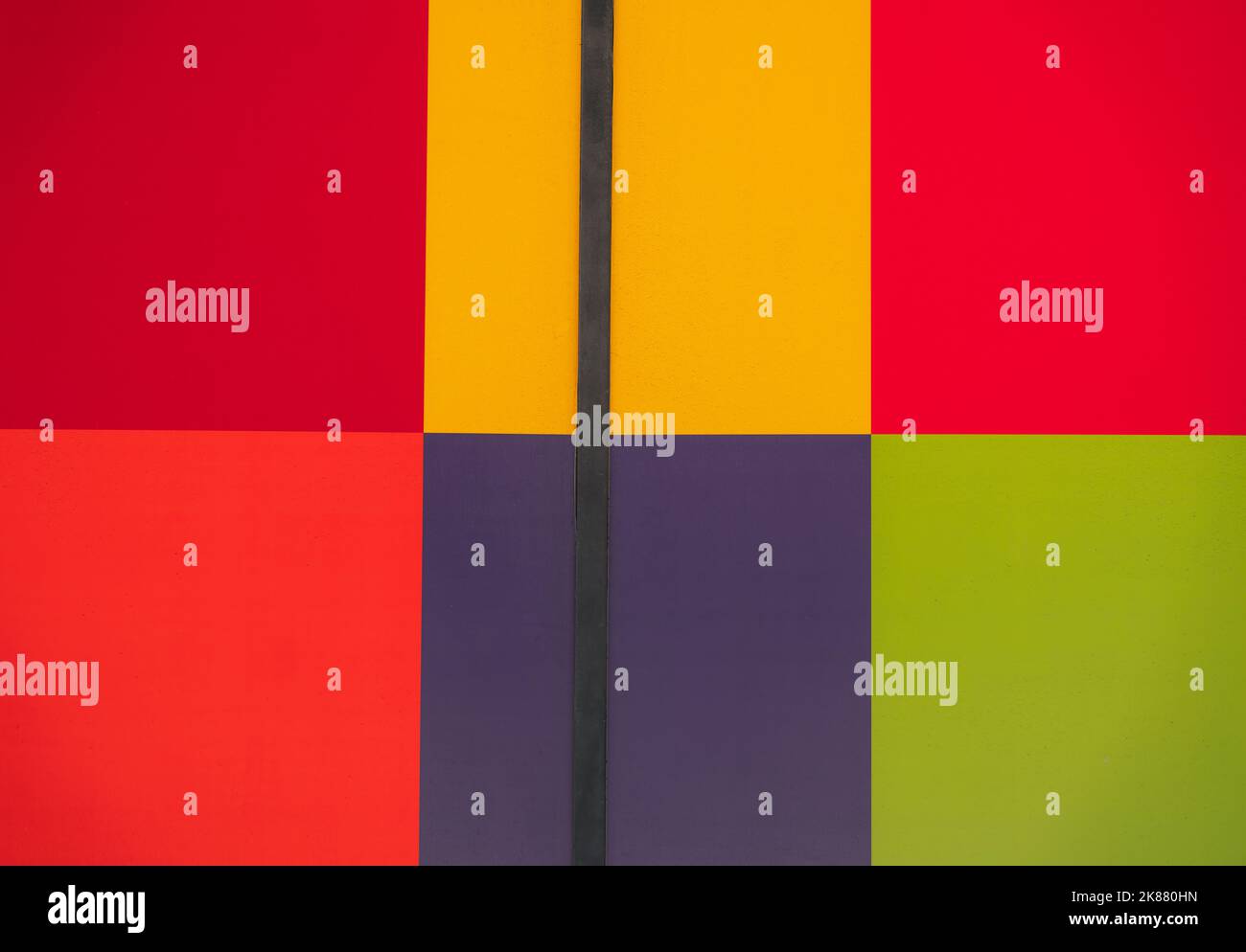 A closeup of a black line in the middle of a colorful wall with ...
