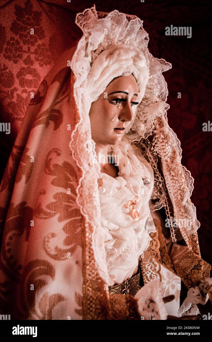 A vertical shot of a crying female statue in vintage clothes Stock ...