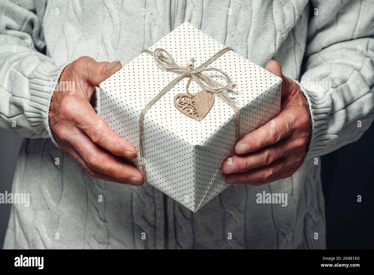Senior man holding present hi-res stock photography and images - Alamy