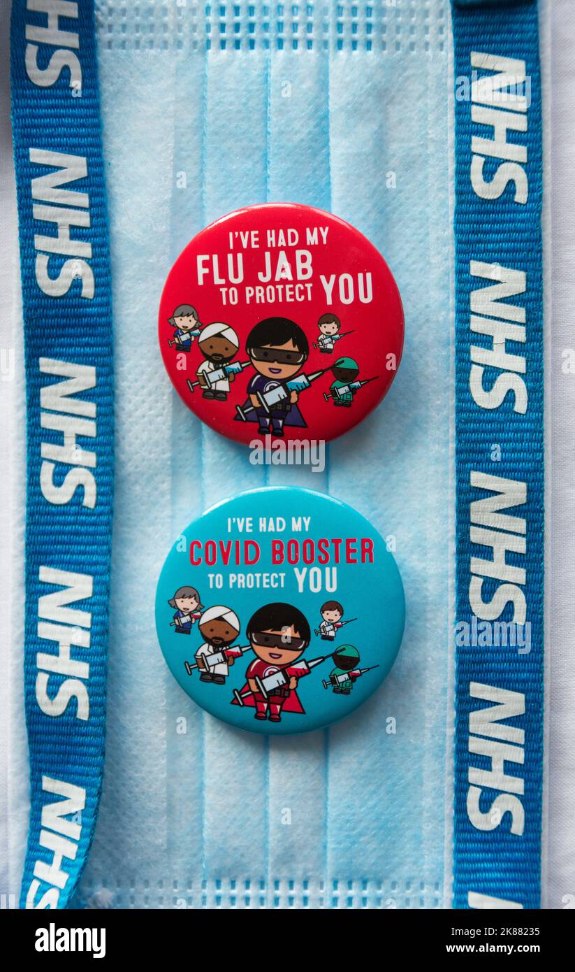 Colourful Covid 19 Booster and Flu Jab badges laying on top of a ...
