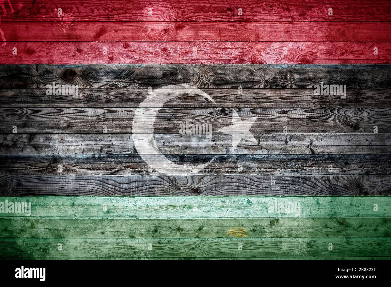 A vignetted background image of the flag of Libya painted onto wooden ...