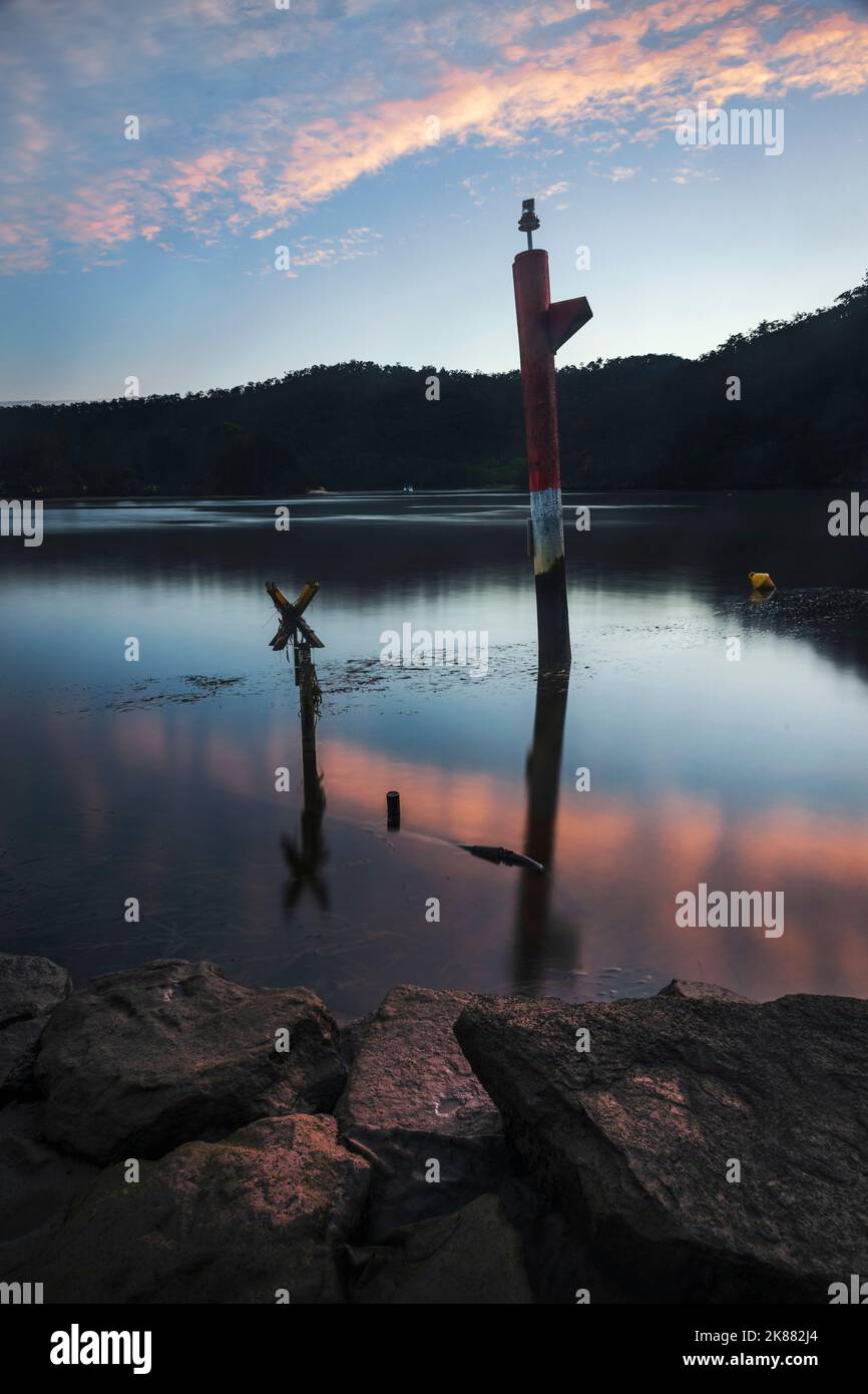 A vertical shot of poles in water Stock Photo - Alamy