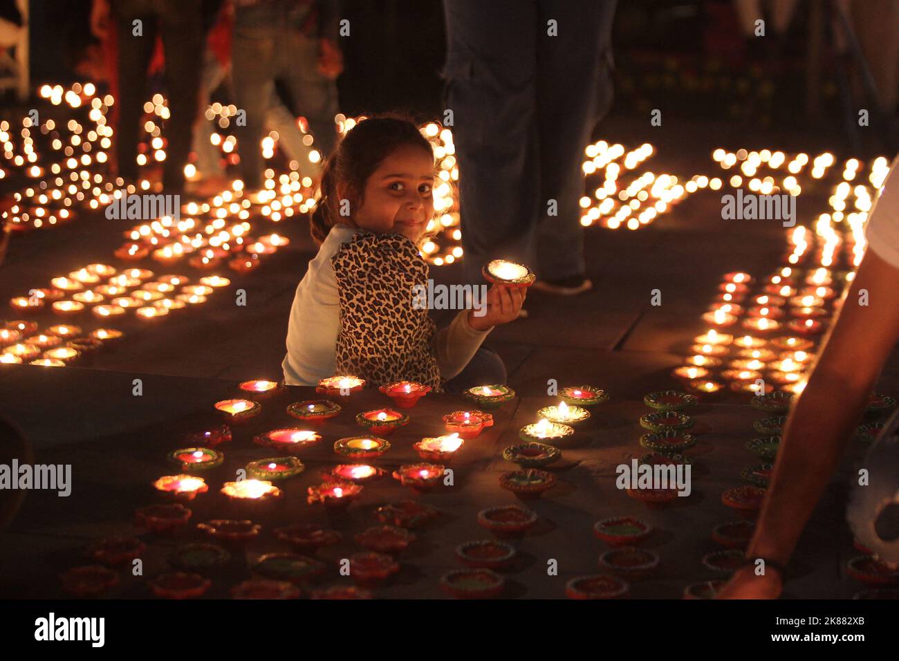 Delhiites light lamps "Diyas" ahead of Diwali during an awareness ...