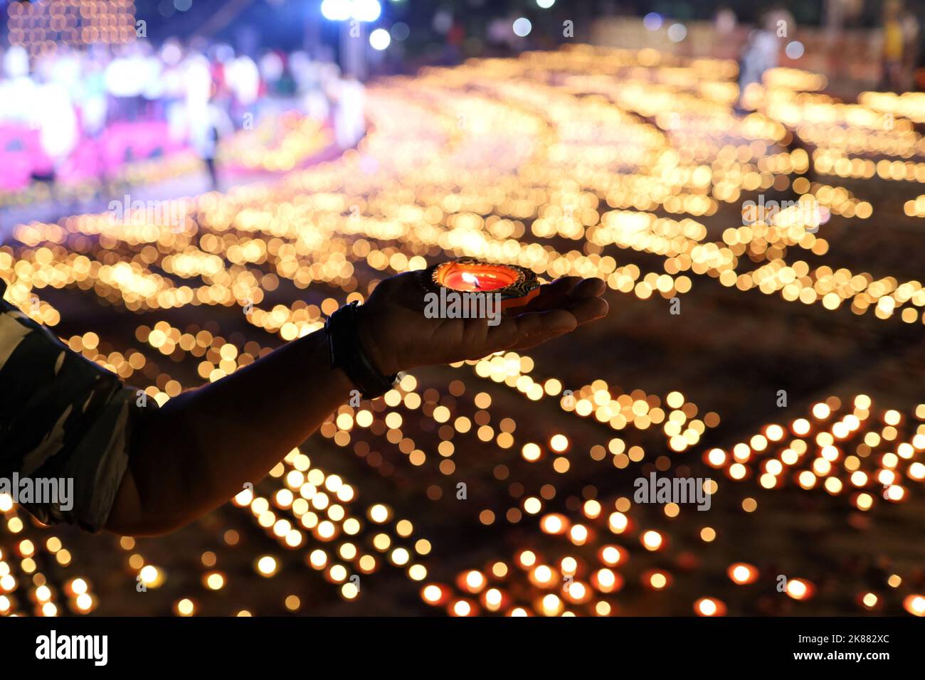 Delhiites light lamps "Diyas" ahead of Diwali during an awareness ...