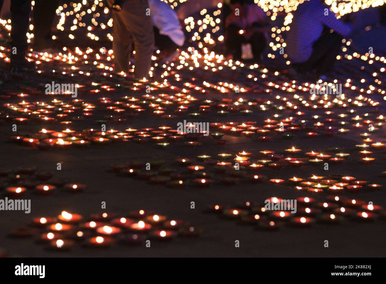 Delhiites light lamps "Diyas" ahead of Diwali during an awareness ...