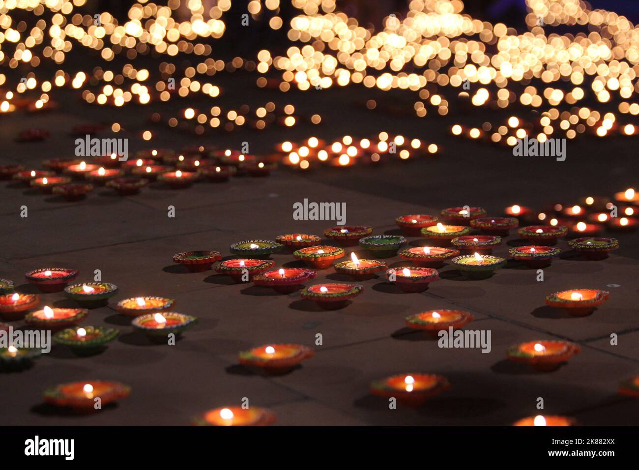 Delhiites light lamps "Diyas" ahead of Diwali during an awareness ...