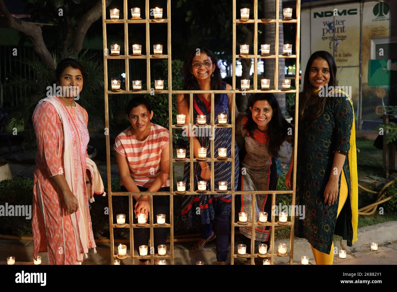 Delhiites light lamps "Diyas" ahead of Diwali during an awareness ...