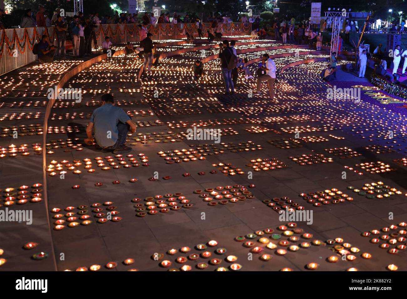 Delhiites light lamps "Diyas" ahead of Diwali during an awareness ...