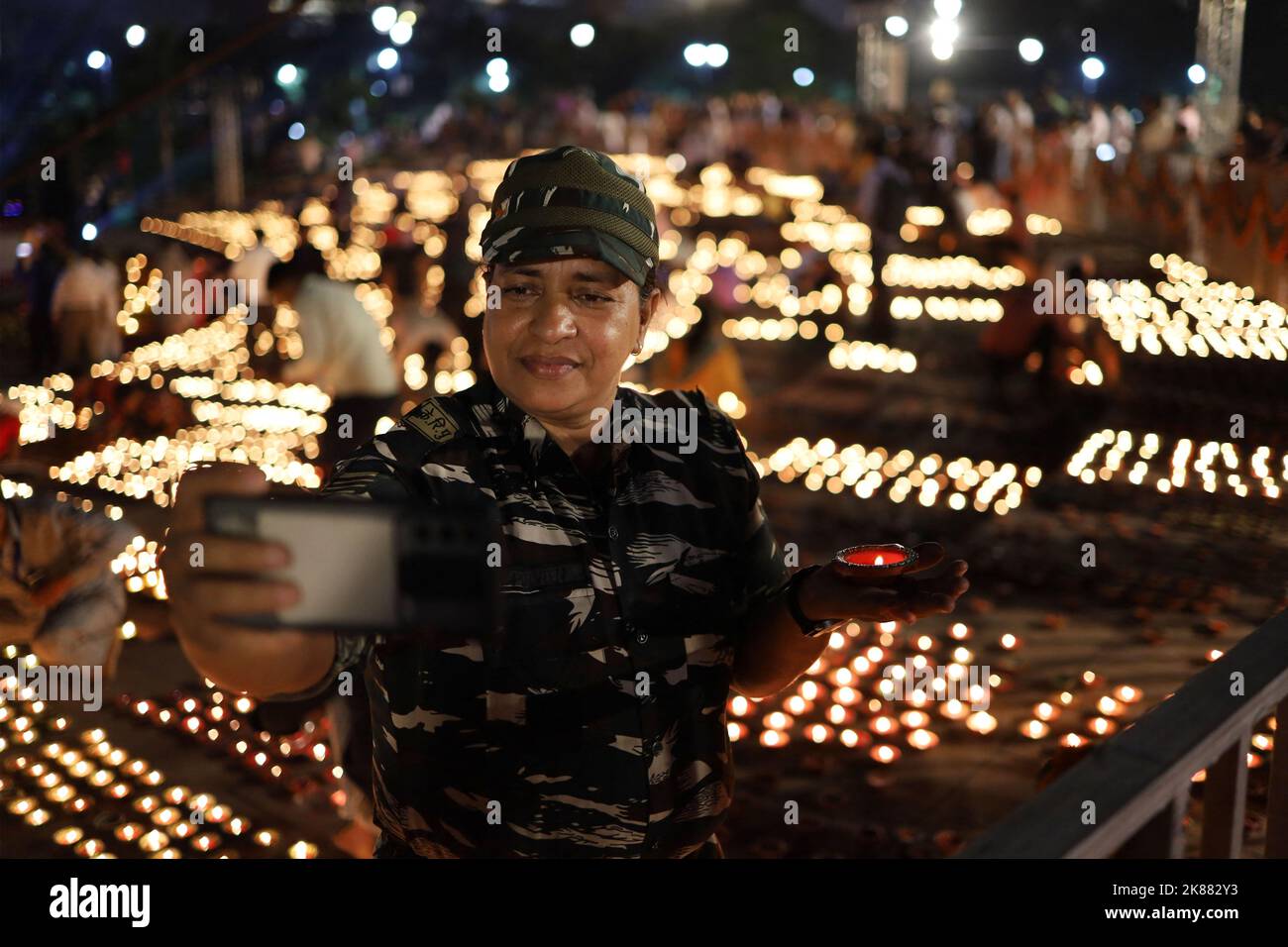 Delhiites light lamps "Diyas" ahead of Diwali during an awareness ...