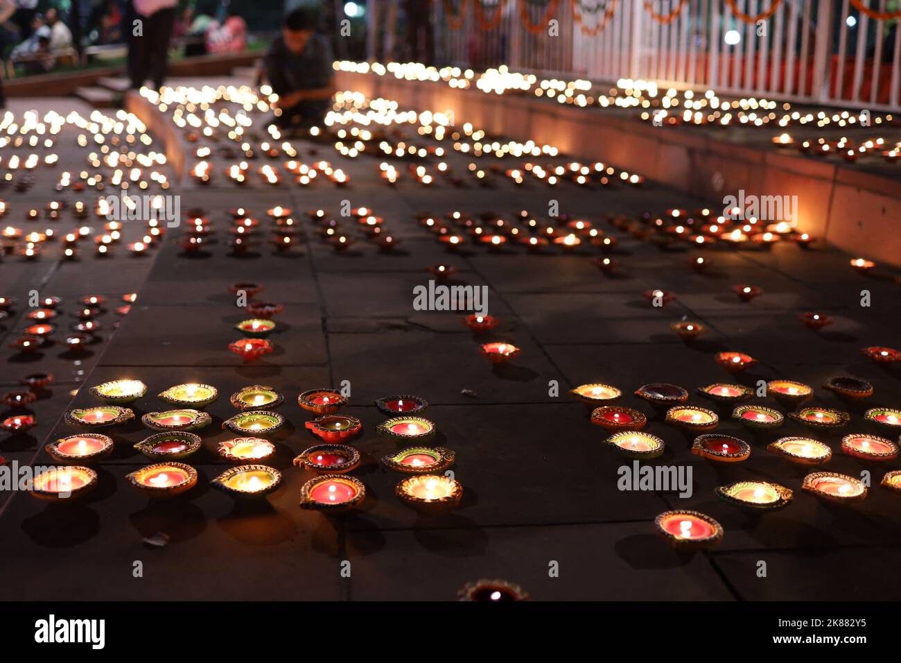 Delhiites light lamps "Diyas" ahead of Diwali during an awareness ...