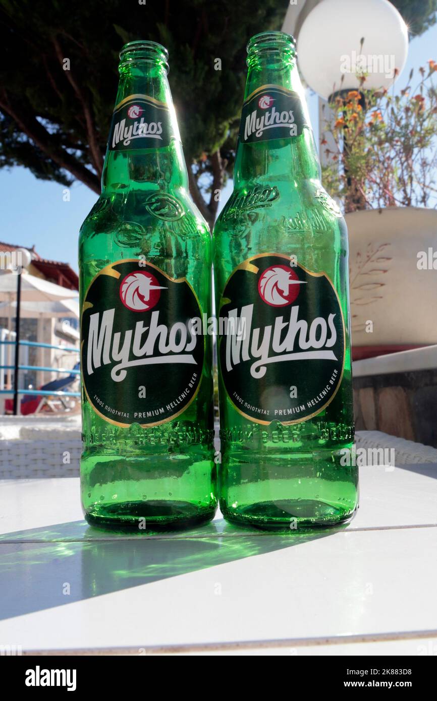 Three Green Mythos Greek beer bottles outdoors on a sunny day. Sept ...