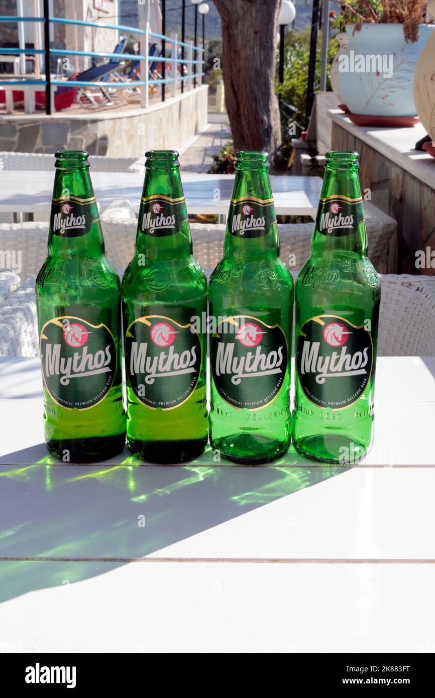 Four Green Mythos Greek beer bottles outdoors on a sunny day. Sept ...