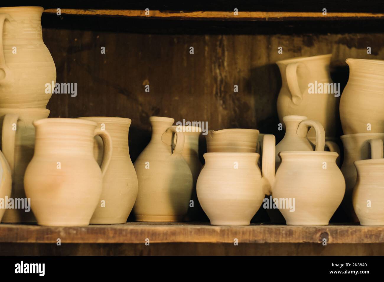 Ceramic clay jugs standing on a shelf in the village Stock Photo - Alamy