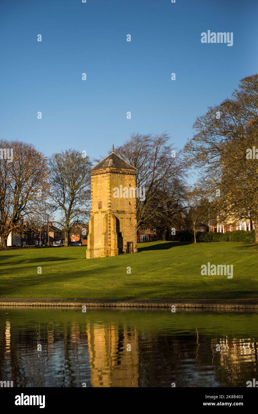 A vertical shot of the historic stone fortress tower in Abington Park ...