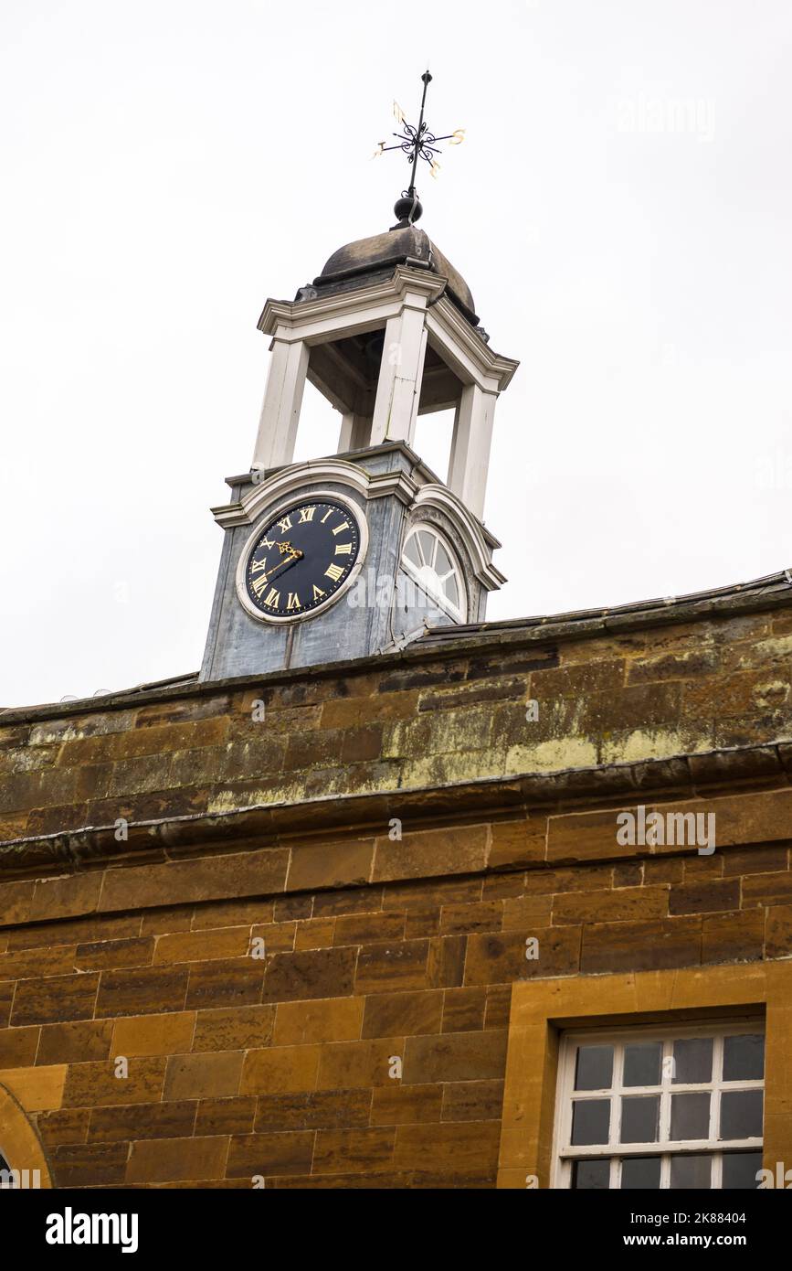 A vertical shot of a historic clock tower in Delepre Abbey, Northampton ...