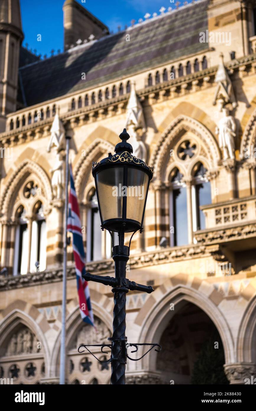 A vertical shot of a lamp near the historic Northampton Guildhall ...