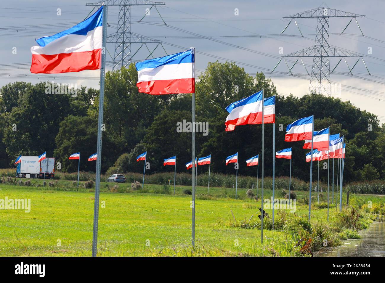 Protest signs and rows of flags upside down in Lekkerkerk along the ...