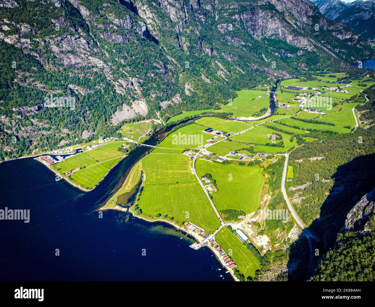 An aerial of a beautiful landscape of a rural area around a lake and a ...