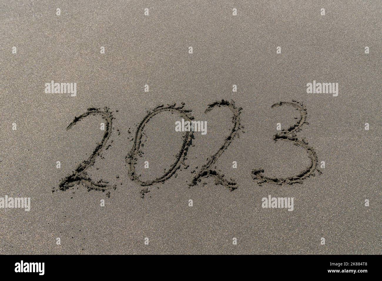 Close-up of the numbers 2023 on the sand, symbols of the new year Stock ...