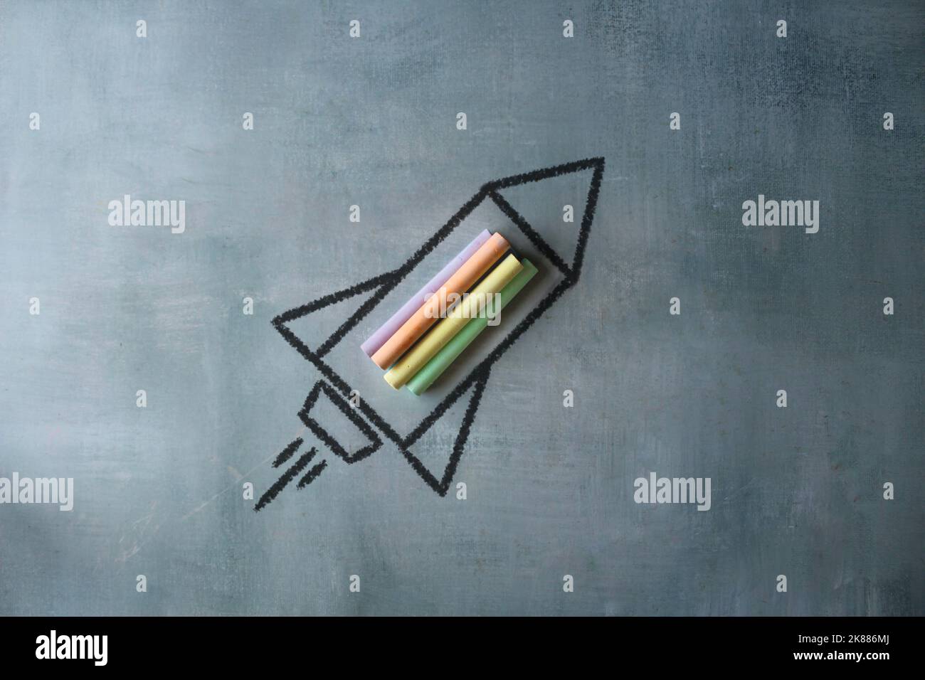 Sketch of rocket ship launch made with colorful chalk on chalkboard ...